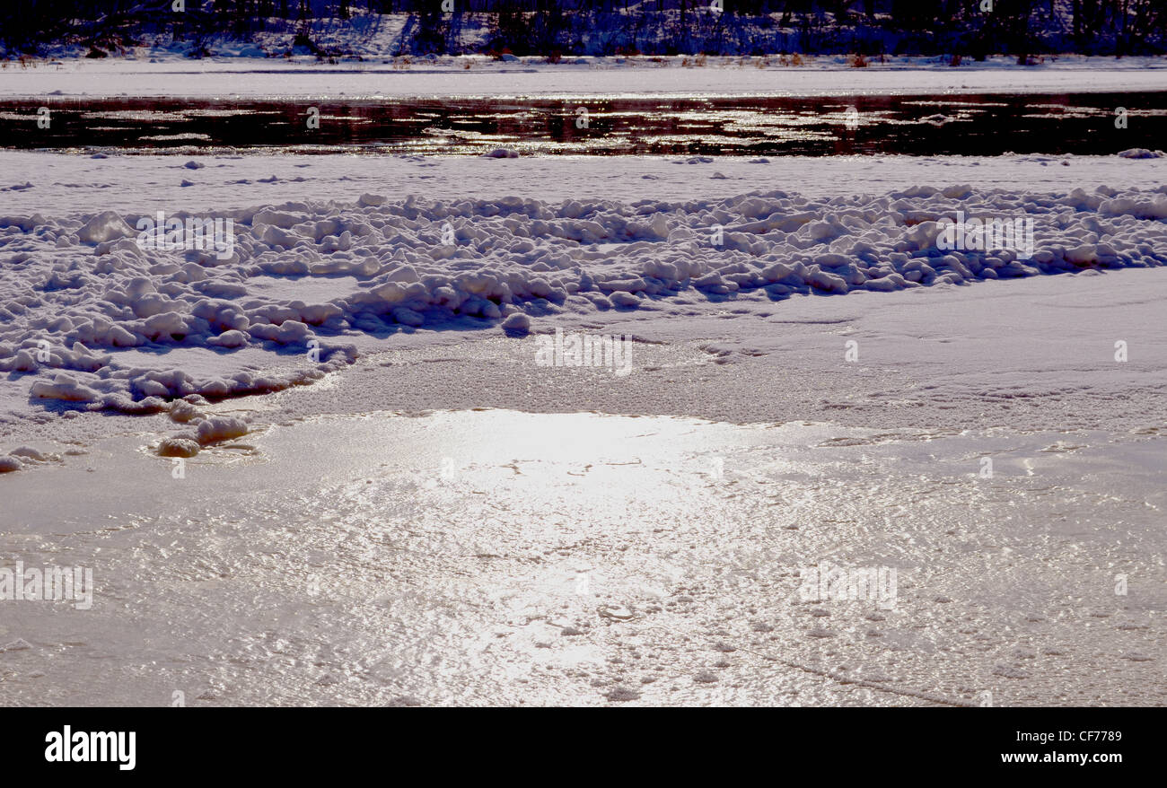 Partially frozen but still flowing river, and floe carried by water ...