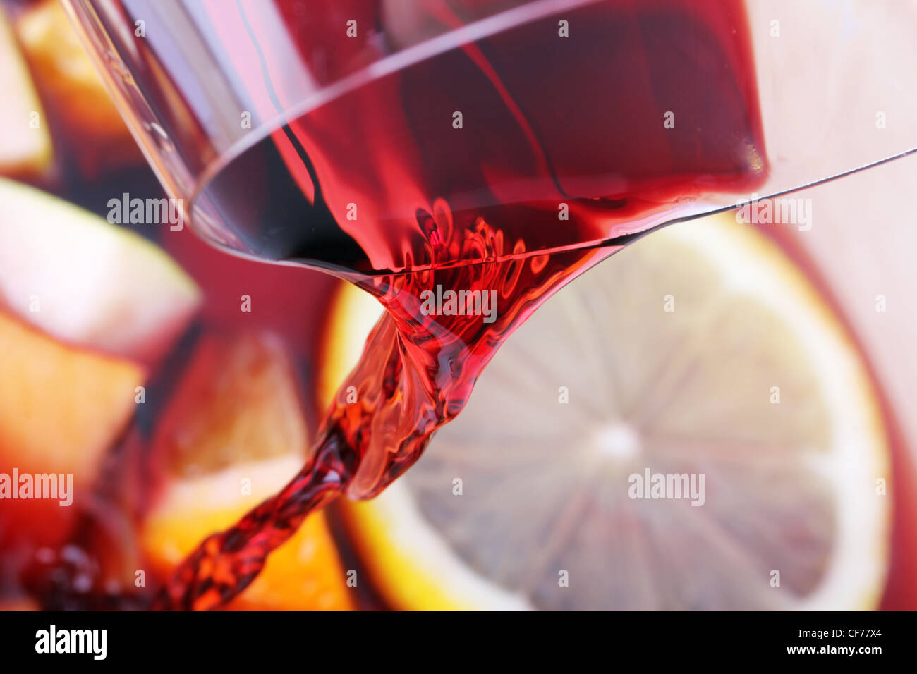 Pouring red wine into juice fruits Stock Photo - Alamy