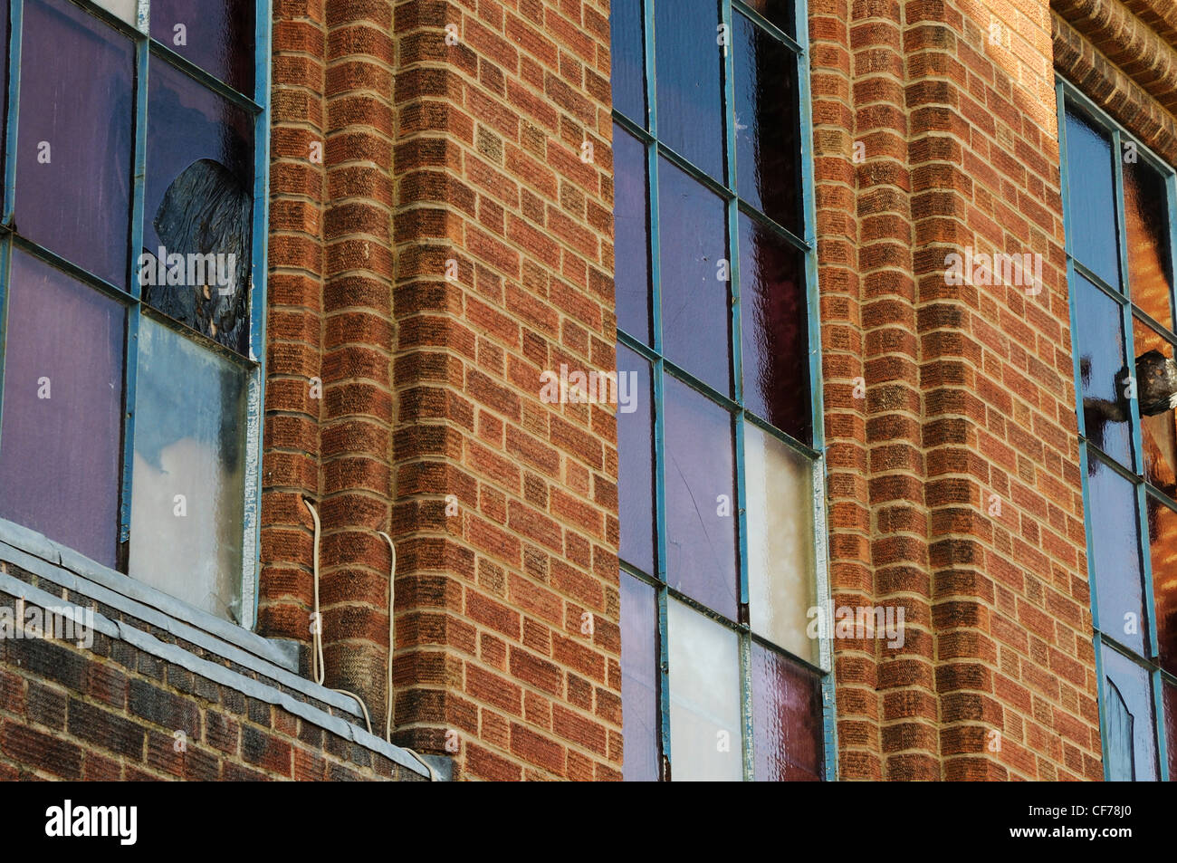 Broken windows in an abandoned building Stock Photo - Alamy