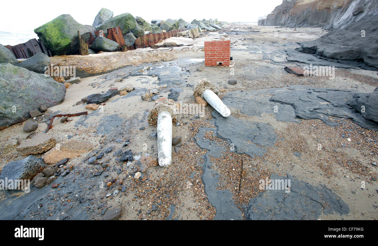 A Manhole with it`s cover and road bollards lay on the beach after ...