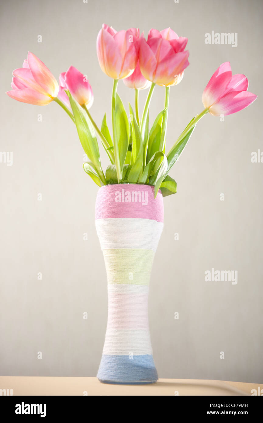 Custom yarn wrapped vase with pink tulips Stock Photo - Alamy
