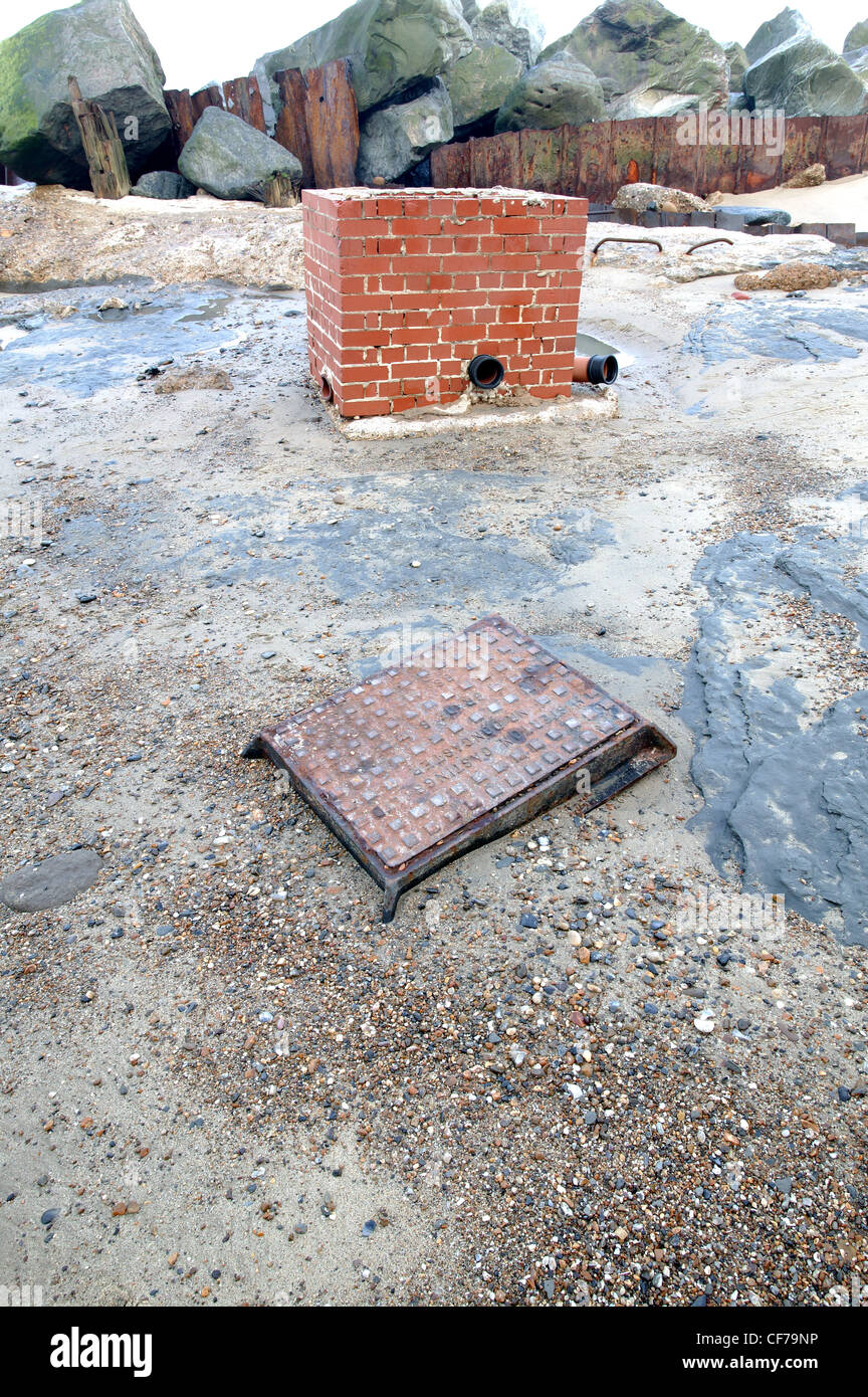 A Manhole with it`s cover lay on the beach after falling from the ...