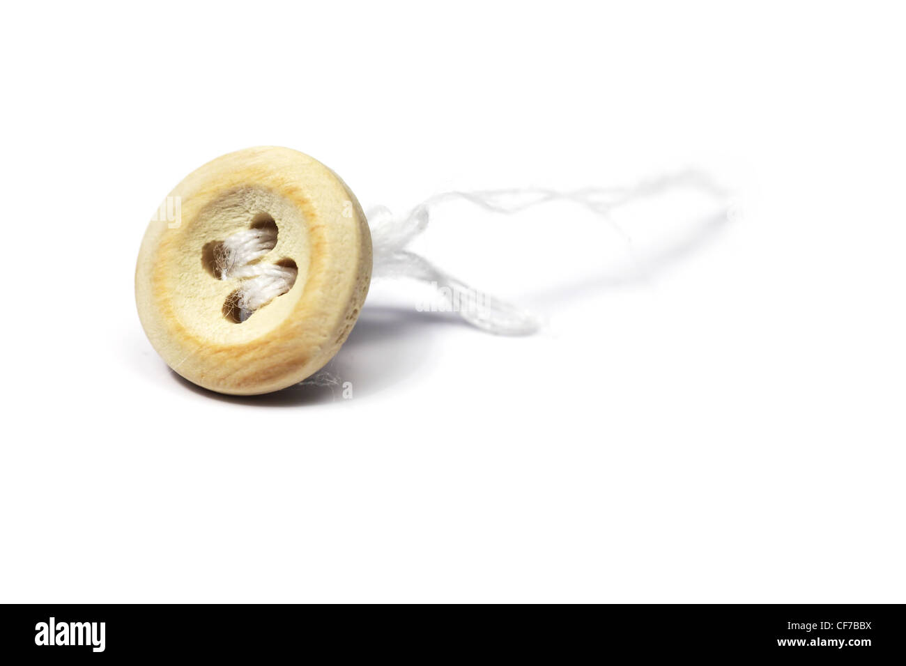 closeup of detached button and thread over white Stock Photo - Alamy