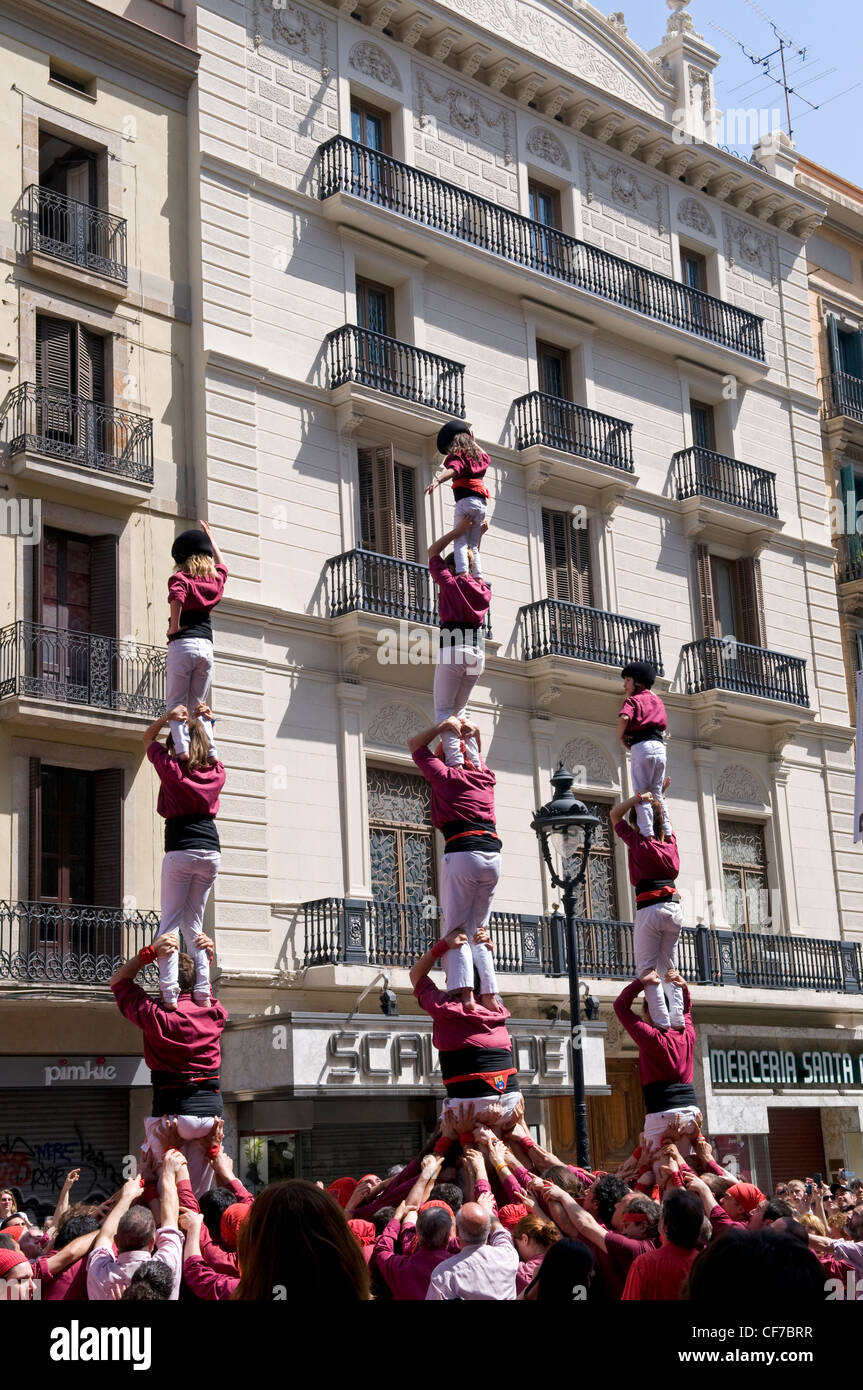 Men, Women and children building human pyramids "towers" on the streets ...