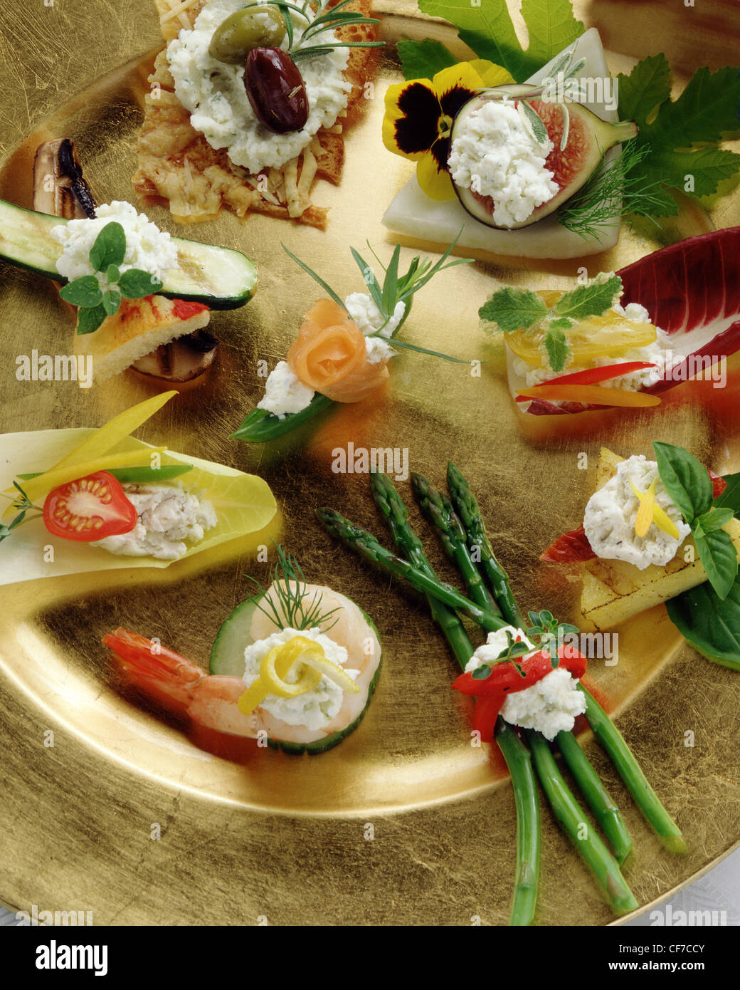 Group of nine beautiful appetizers placed on a gold plate Stock Photo ...