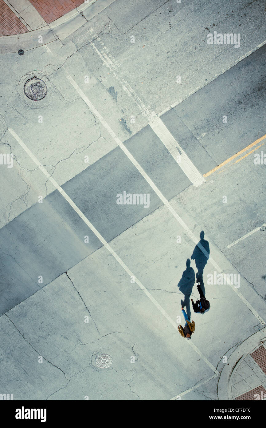 Walking shadows of two men crossing the street Stock Photo - Alamy