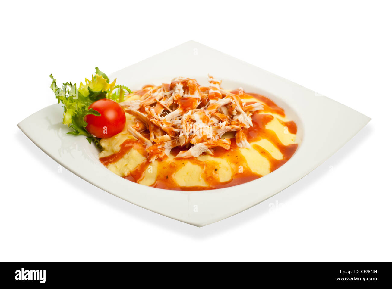 Puree with chicken piece and sauce on a plateau isolated on white ...