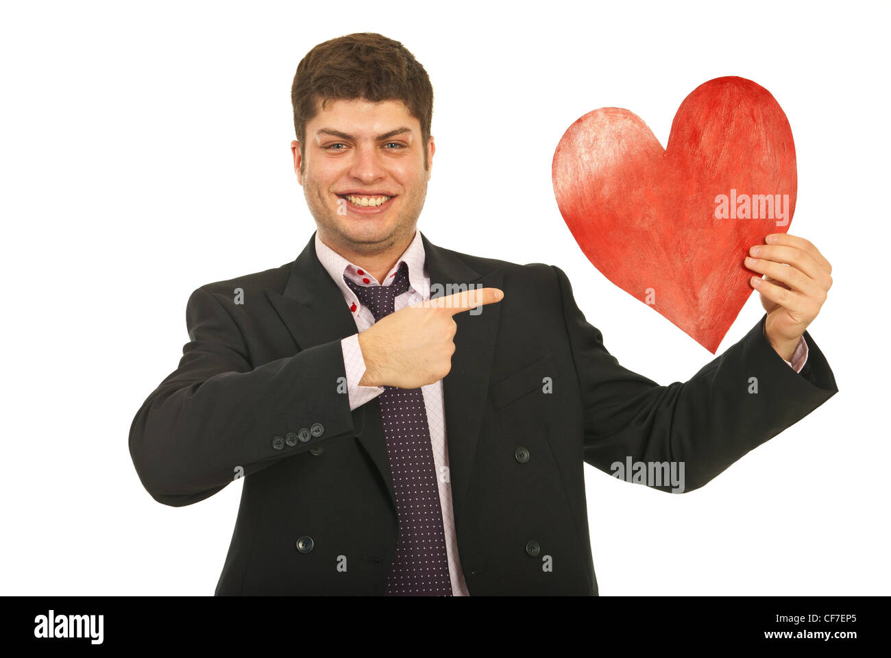 Happy business man pointing to heart shape isolated on white background ...