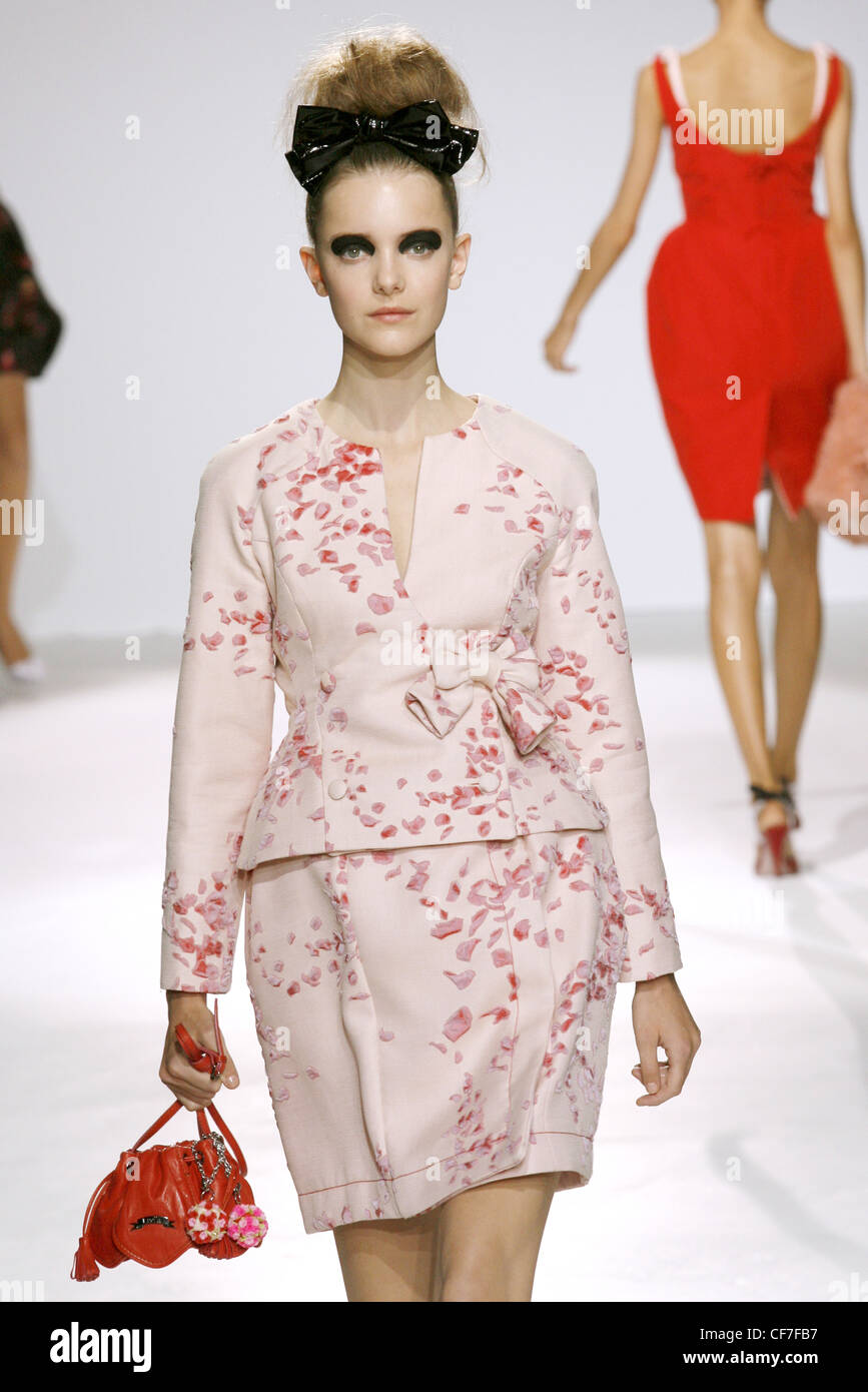 A pale pink petal patterned wrap over jacket bow, a matching wrap over ...