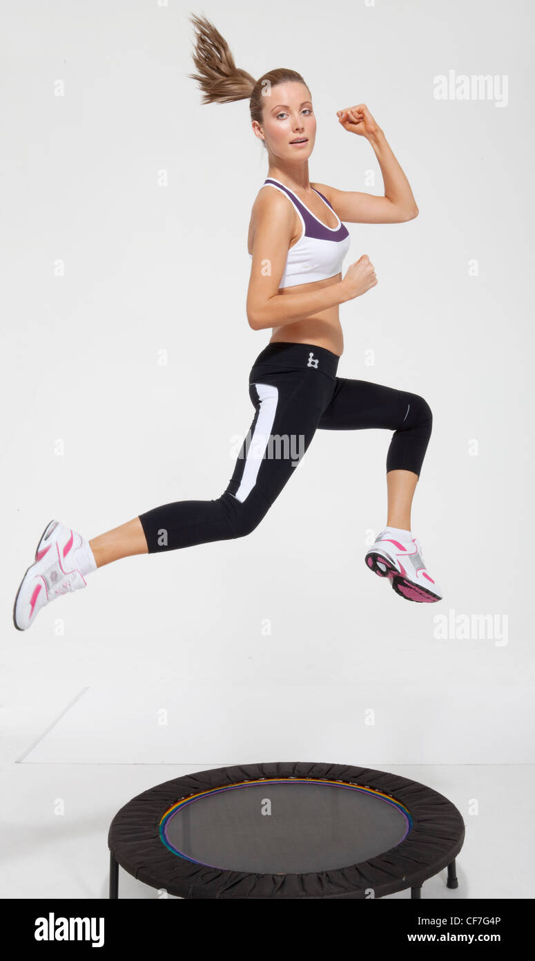 Female fair hair tied into ponytail, wearing a cropped vest, black ...