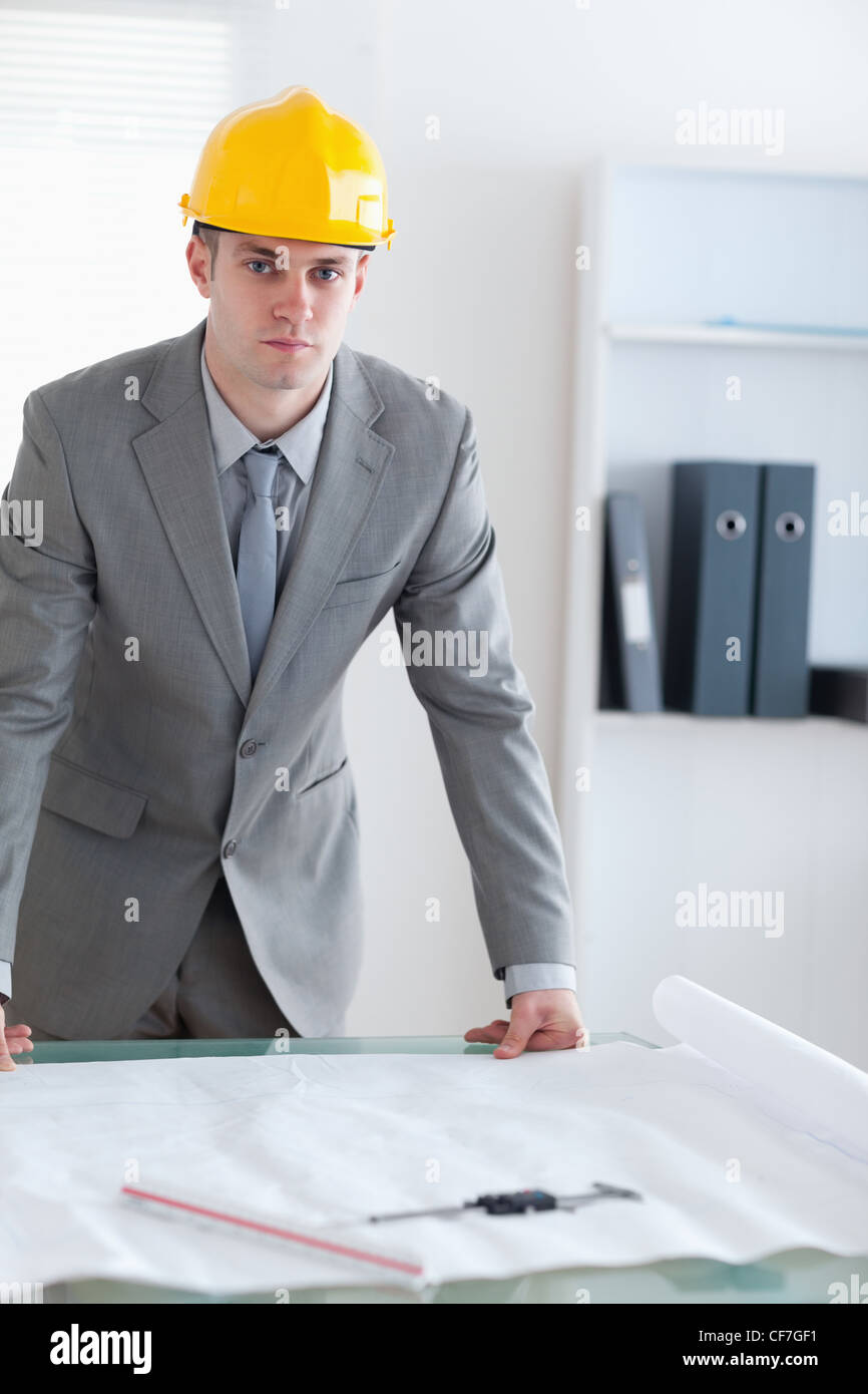 Architect with helmet on standing Stock Photo - Alamy