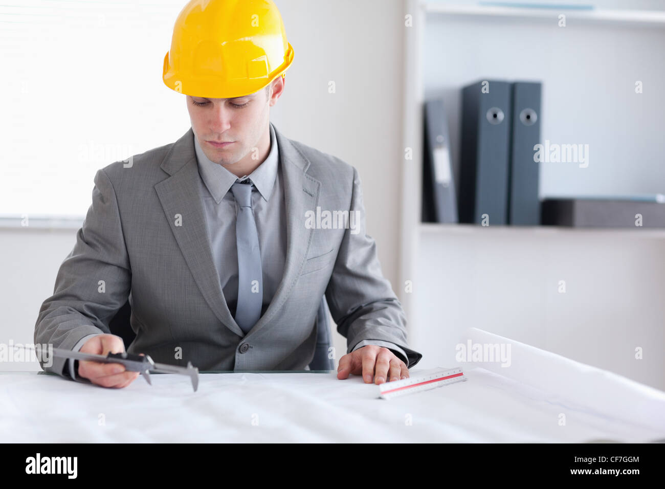 Architect checking plan Stock Photo - Alamy