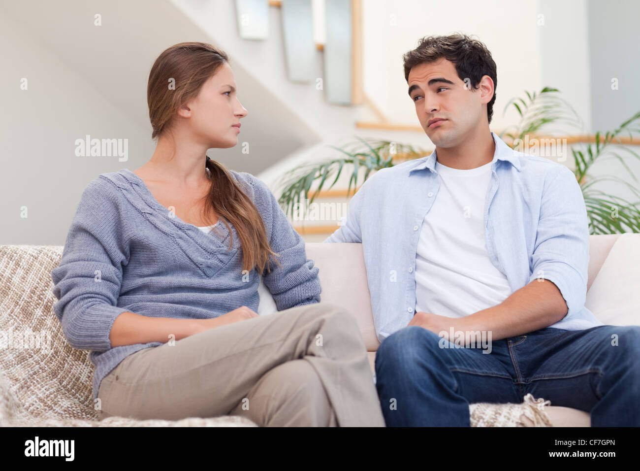 Young couple having an argument while watching TV Stock Photo - Alamy