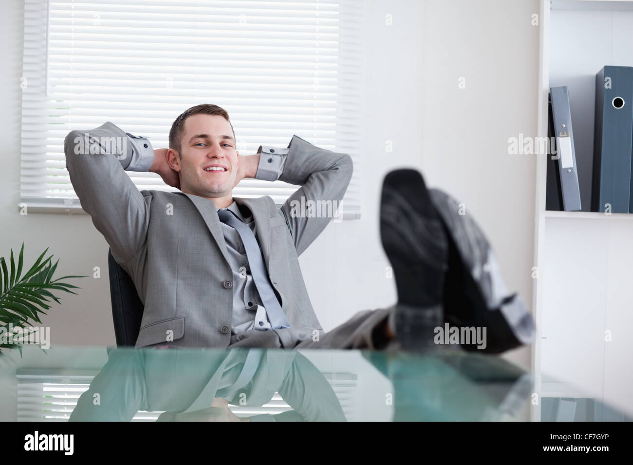 Happy businessman taking a rest Stock Photo - Alamy