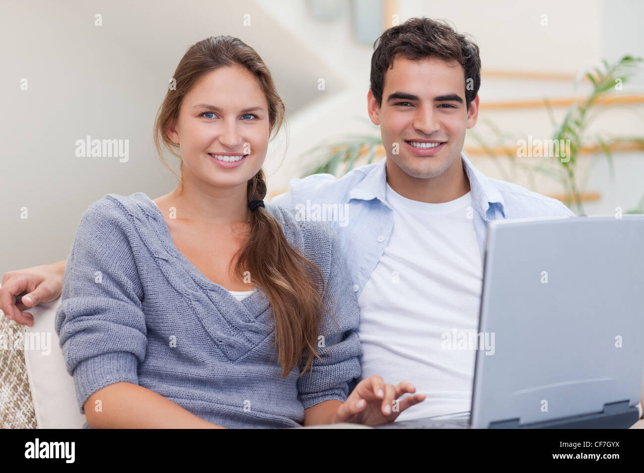Couple using a notebook Stock Photo - Alamy