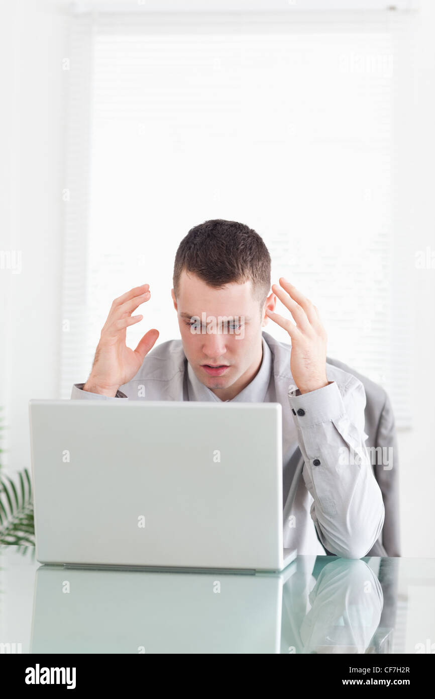 Businessman having problems with laptop Stock Photo - Alamy