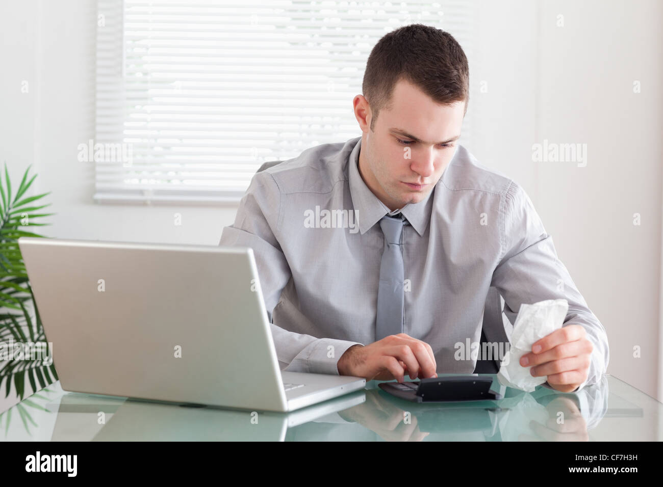 Businessman doing his calculation Stock Photo - Alamy