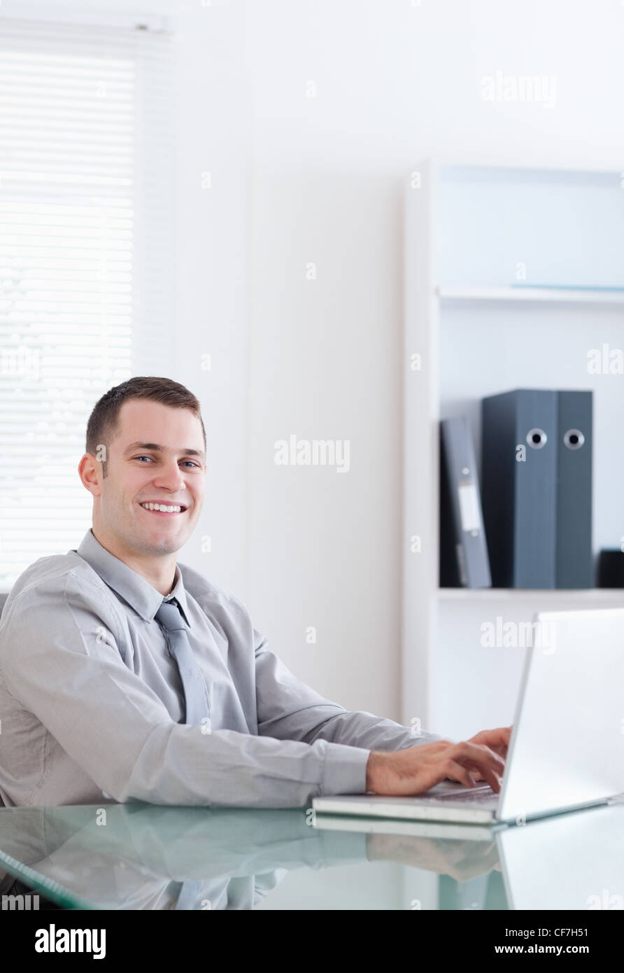 Happy businessman using his laptop Stock Photo - Alamy