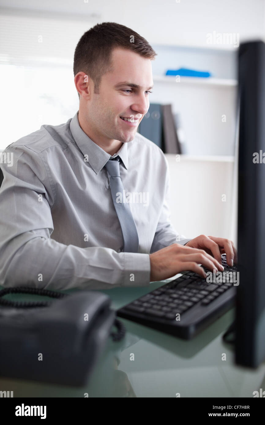 Smiling businessman working on his computer Stock Photo - Alamy