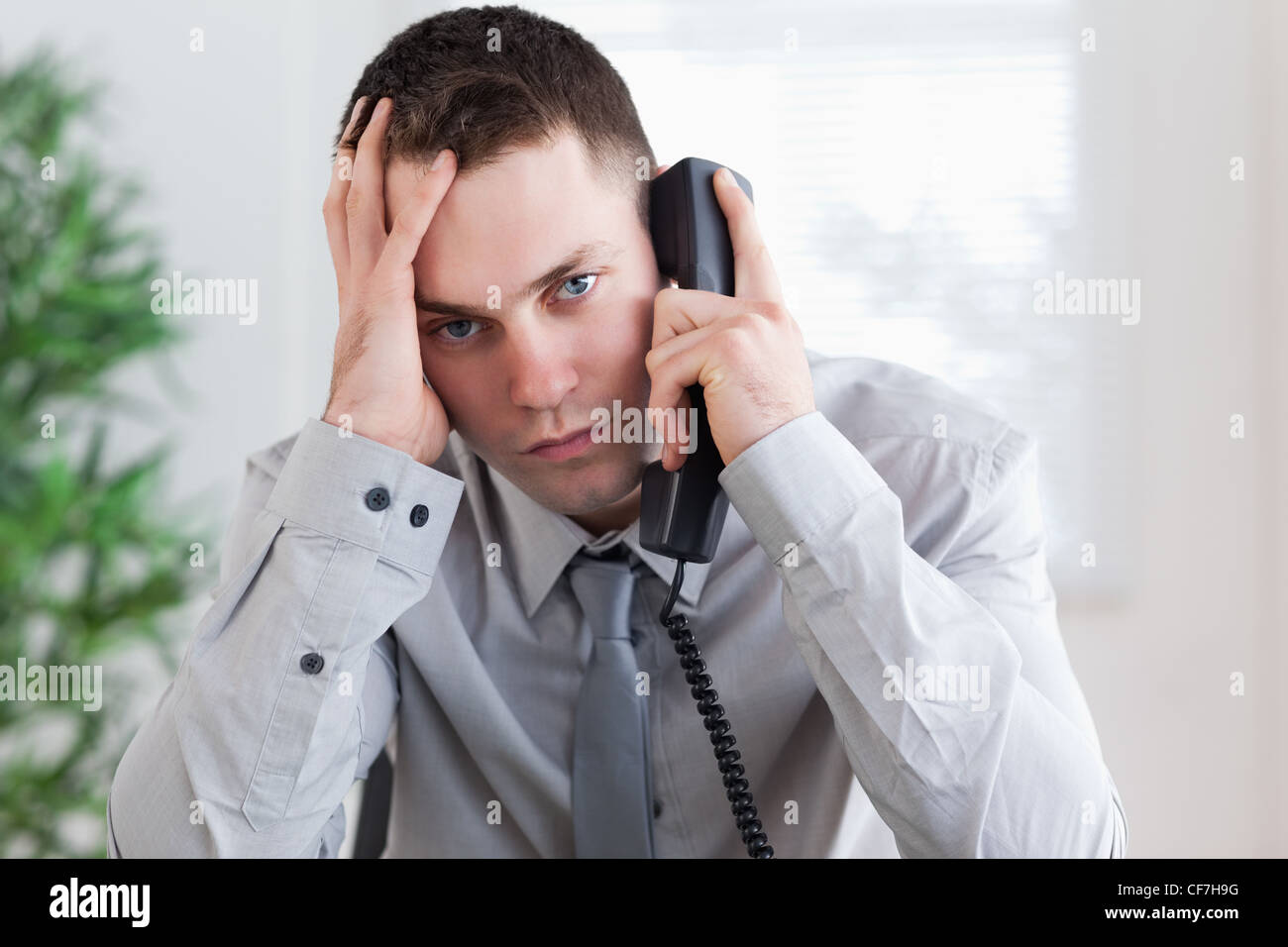 Businessman getting bad news on the phone Stock Photo - Alamy