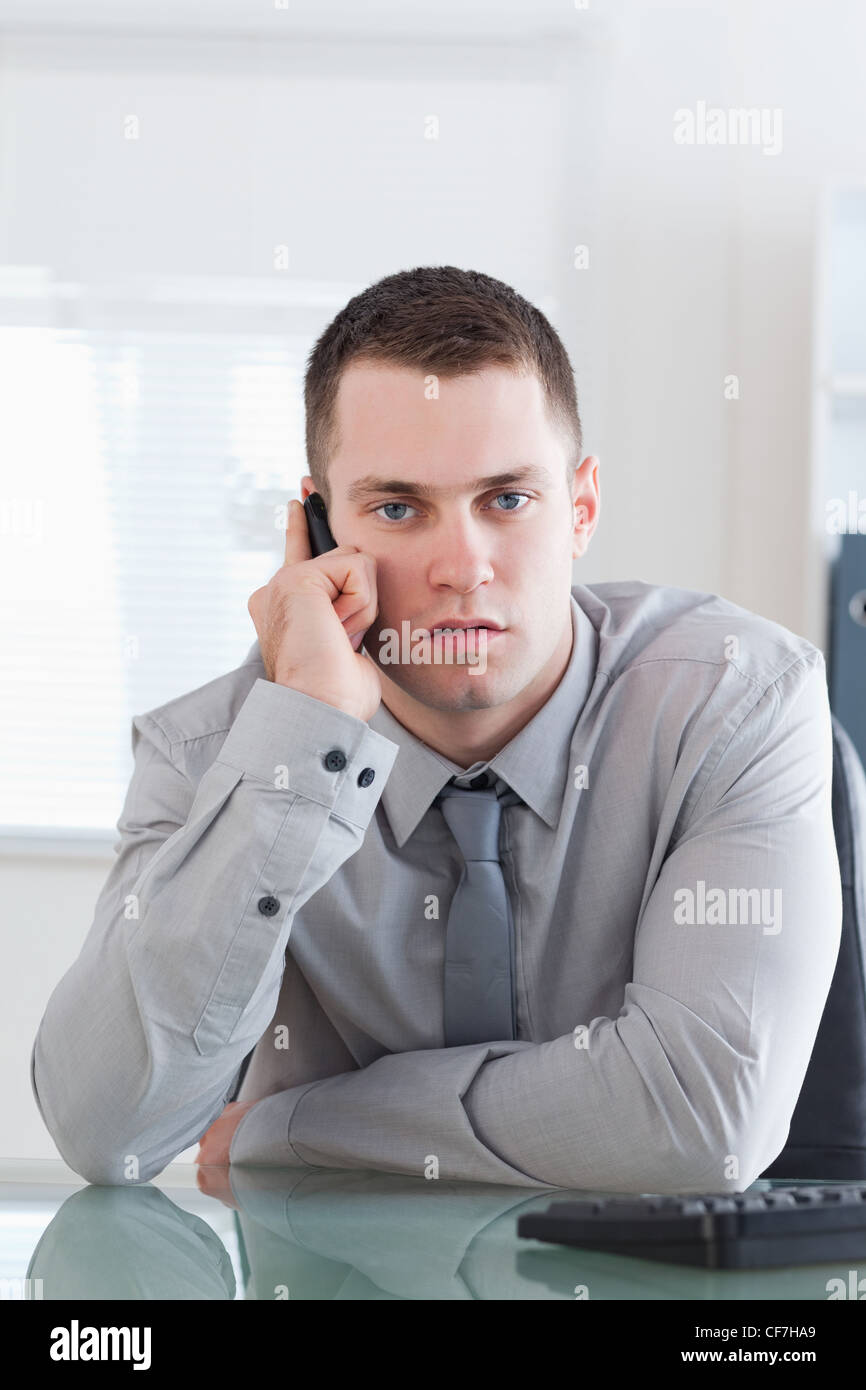 Businessman getting a serious call on his cellphone Stock Photo - Alamy