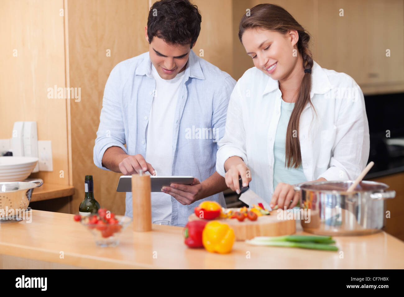 Couple using a tablet computer to cook Stock Photo - Alamy