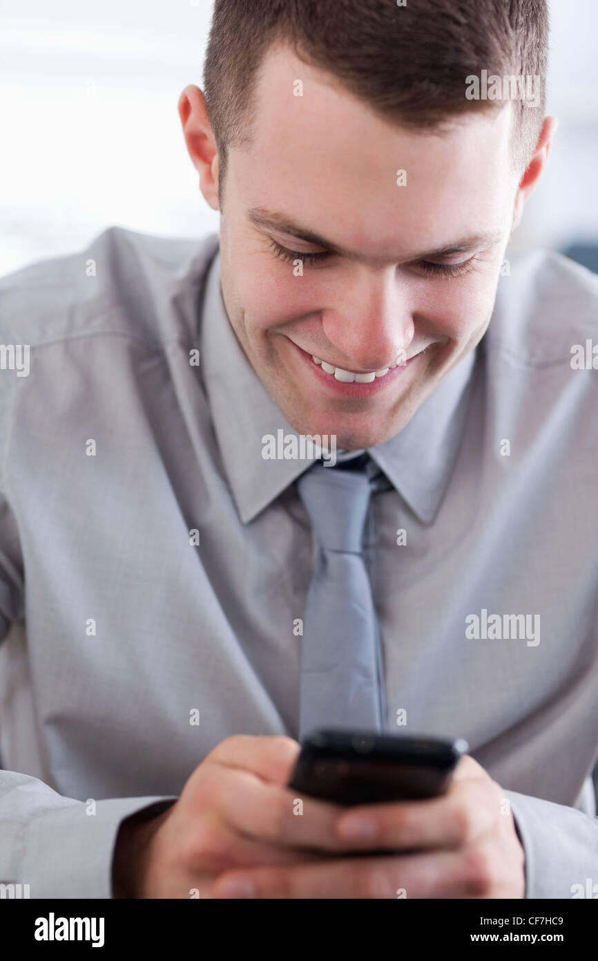 Close up of businessman getting a pleasant text message Stock Photo - Alamy