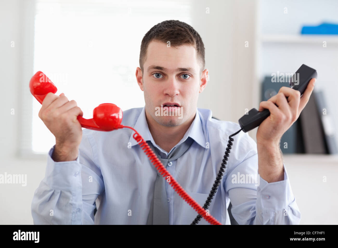 Overextended with the phone Stock Photo - Alamy