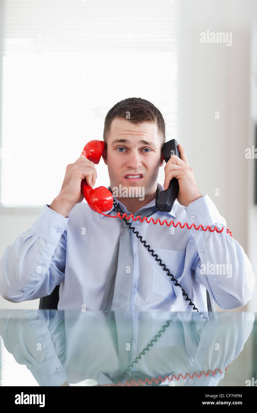 Businessman getting overextended by the telephone Stock Photo - Alamy Businessman getting overextended by the telephone Stock Photo - Alamy