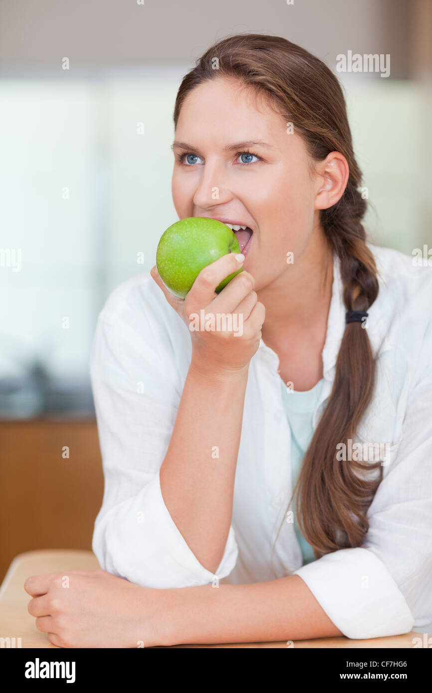 Portrait of a lovely woman eating an apple Stock Photo - Alamy