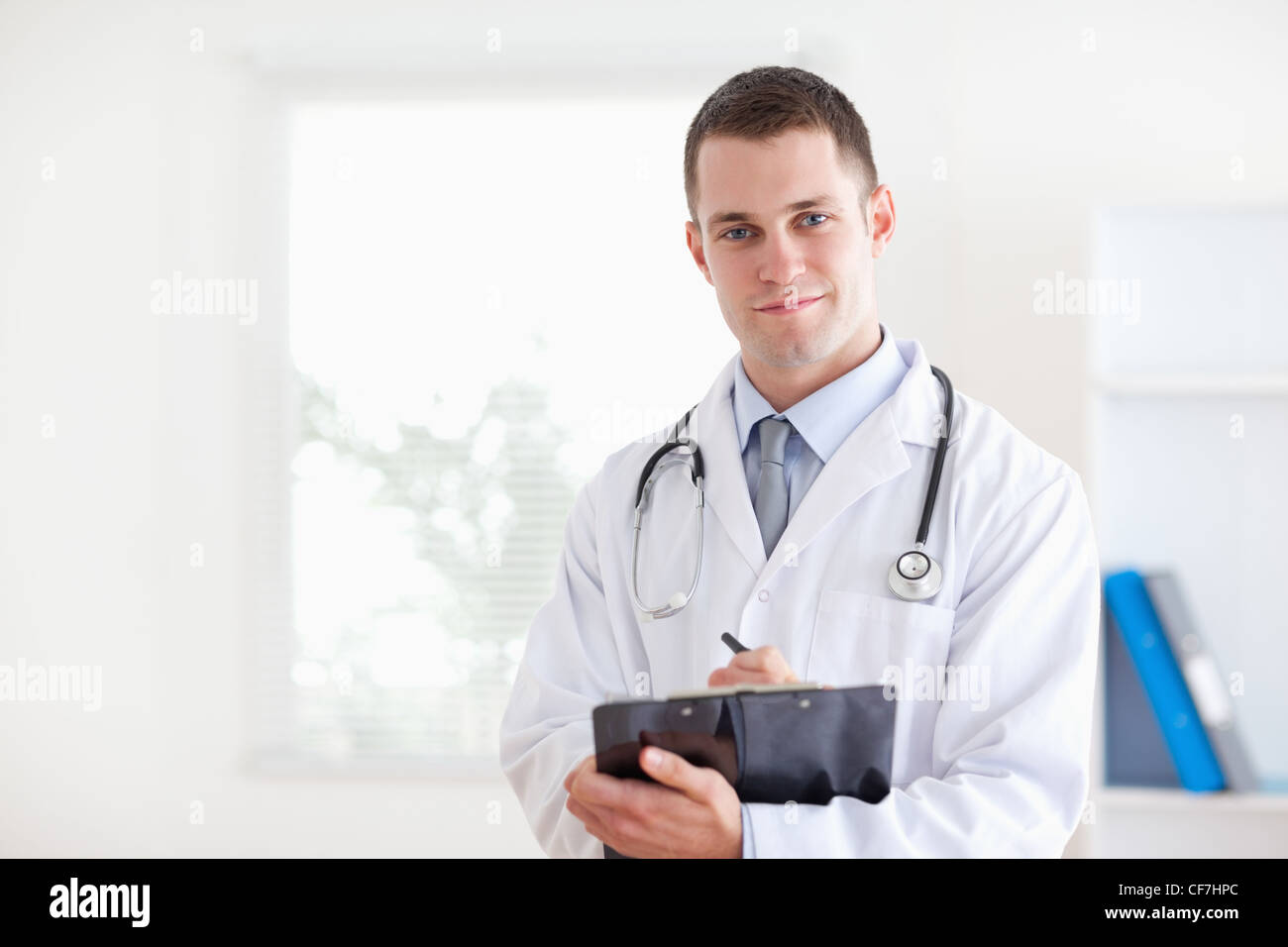 Doctor stethoscope taking notes hi-res stock photography and images - Alamy
