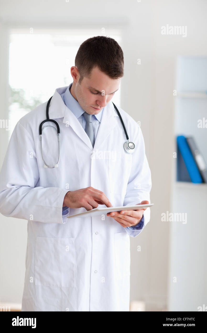 Doctor using his tablet Stock Photo - Alamy