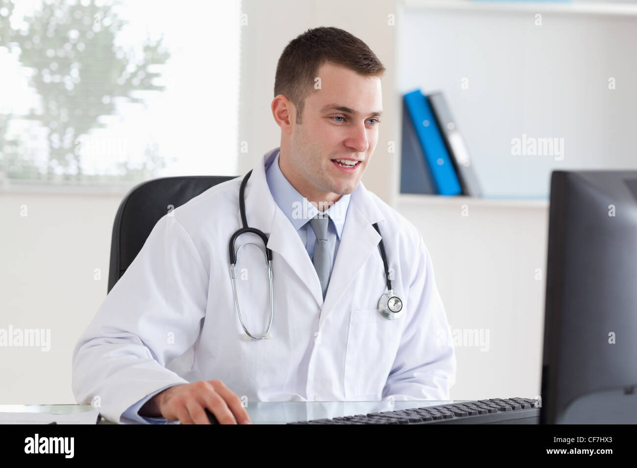 Doctor using his computer Stock Photo - Alamy