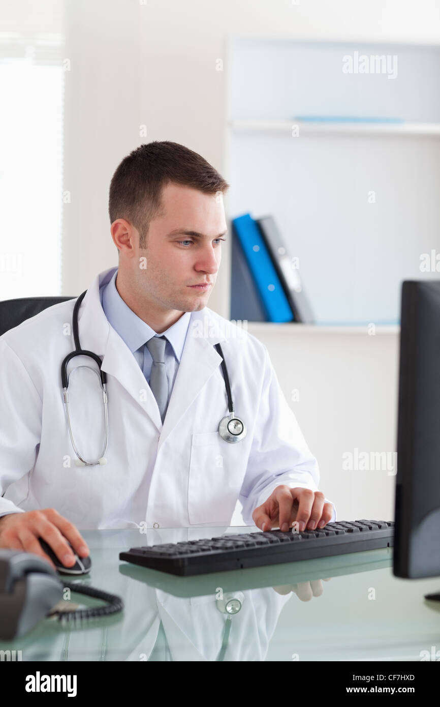 Doctor working with his computer Stock Photo - Alamy