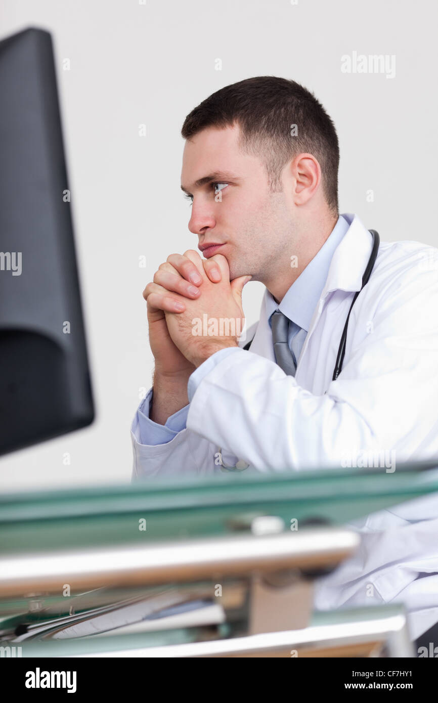 Close up of doctor reading something on his screen Stock Photo - Alamy