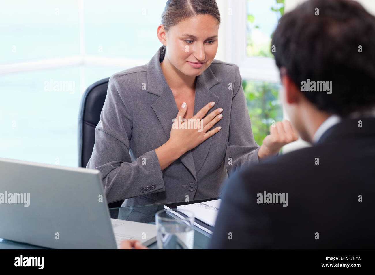Businesswoman talking to customer Stock Photo - Alamy
