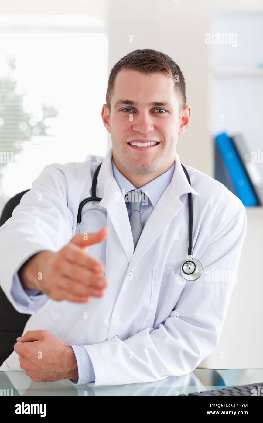 Healthcare professional extending hand hi-res stock photography and ...