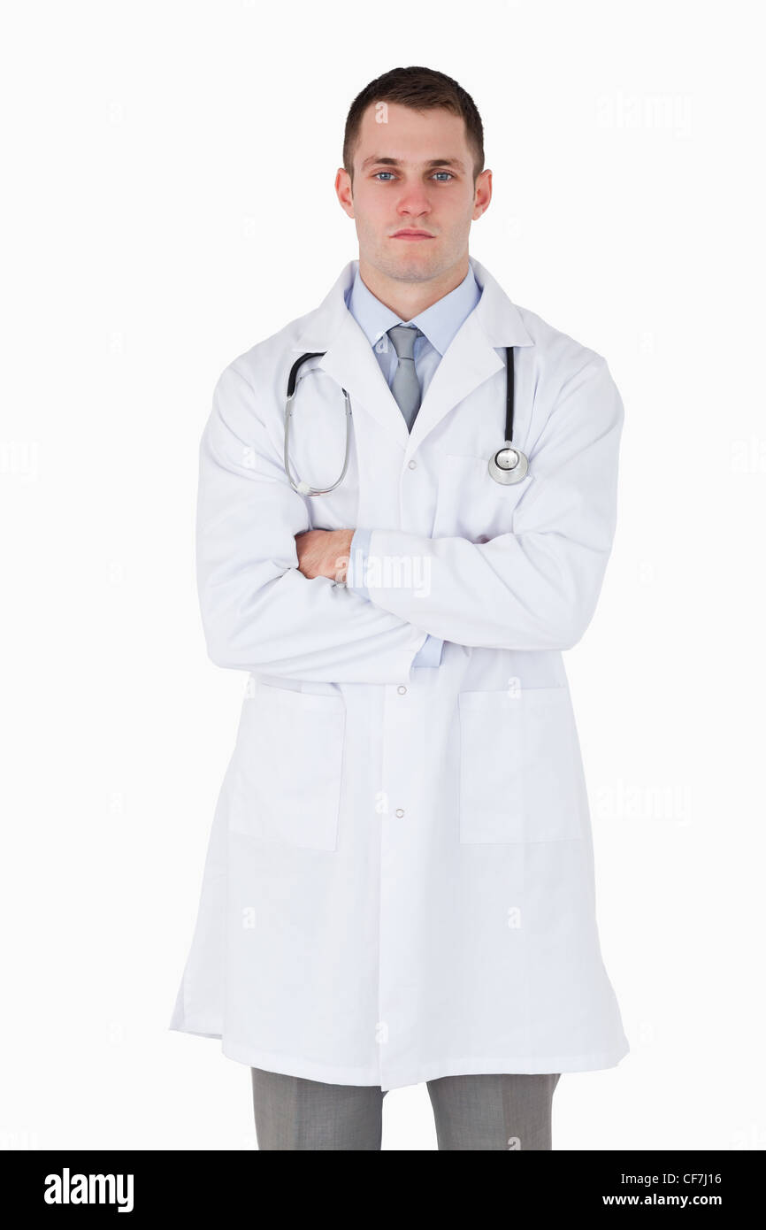 Serious looking doctor with arms folded Stock Photo - Alamy