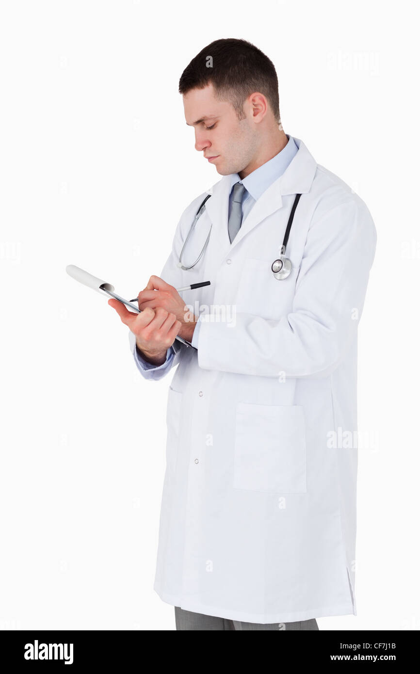Doctor carefully taking notes Stock Photo - Alamy