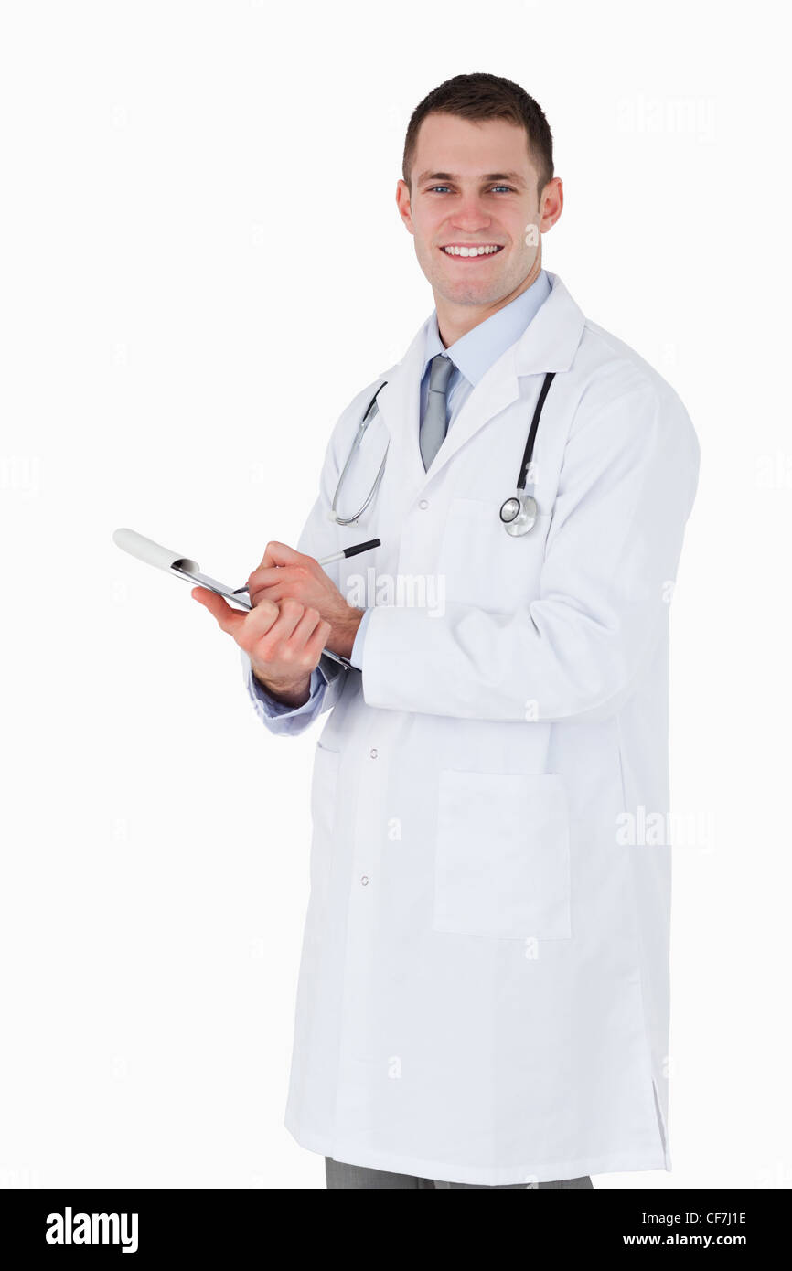 Smiling doctor taking notes Stock Photo - Alamy