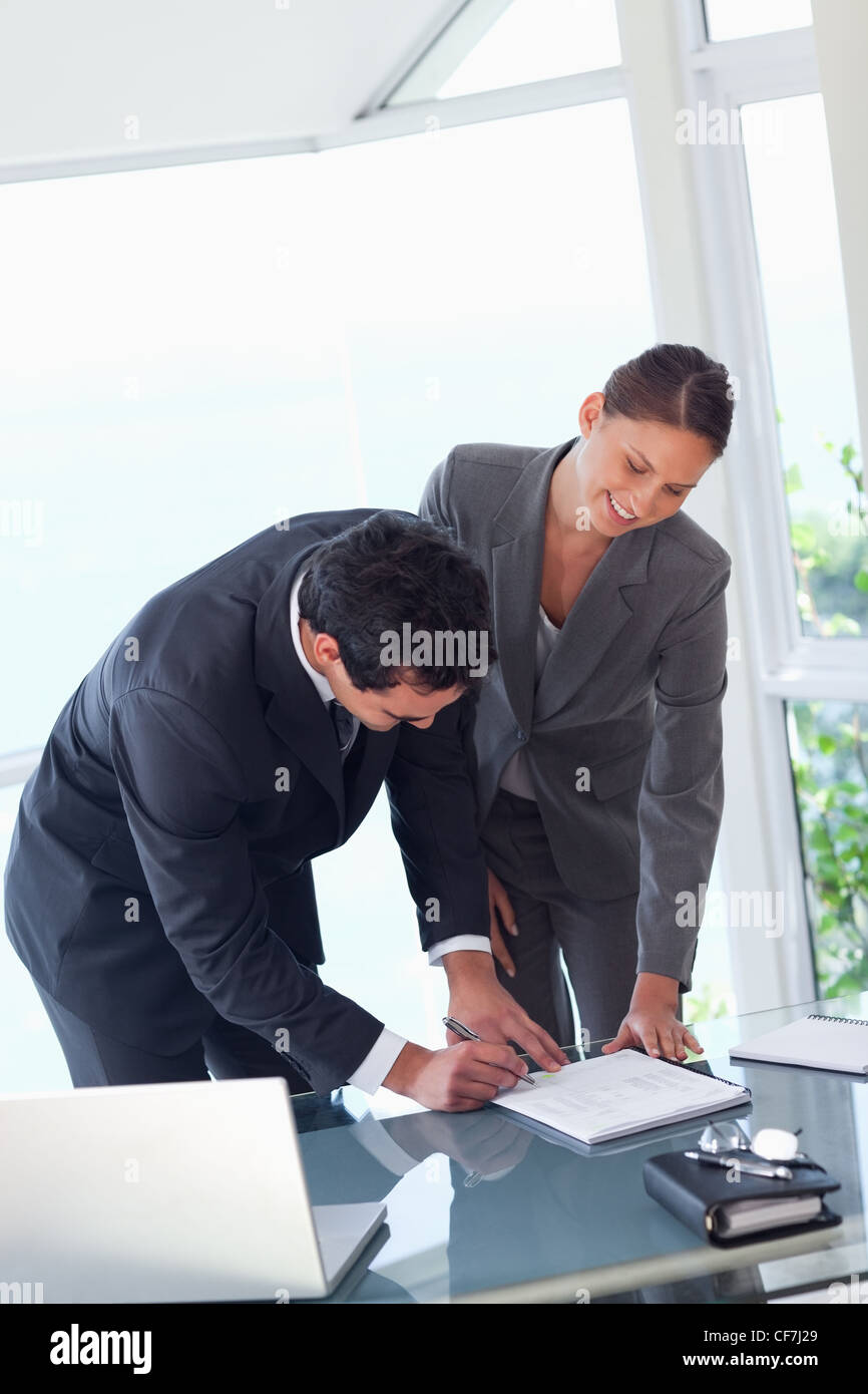 Business partners signing contract Stock Photo - Alamy