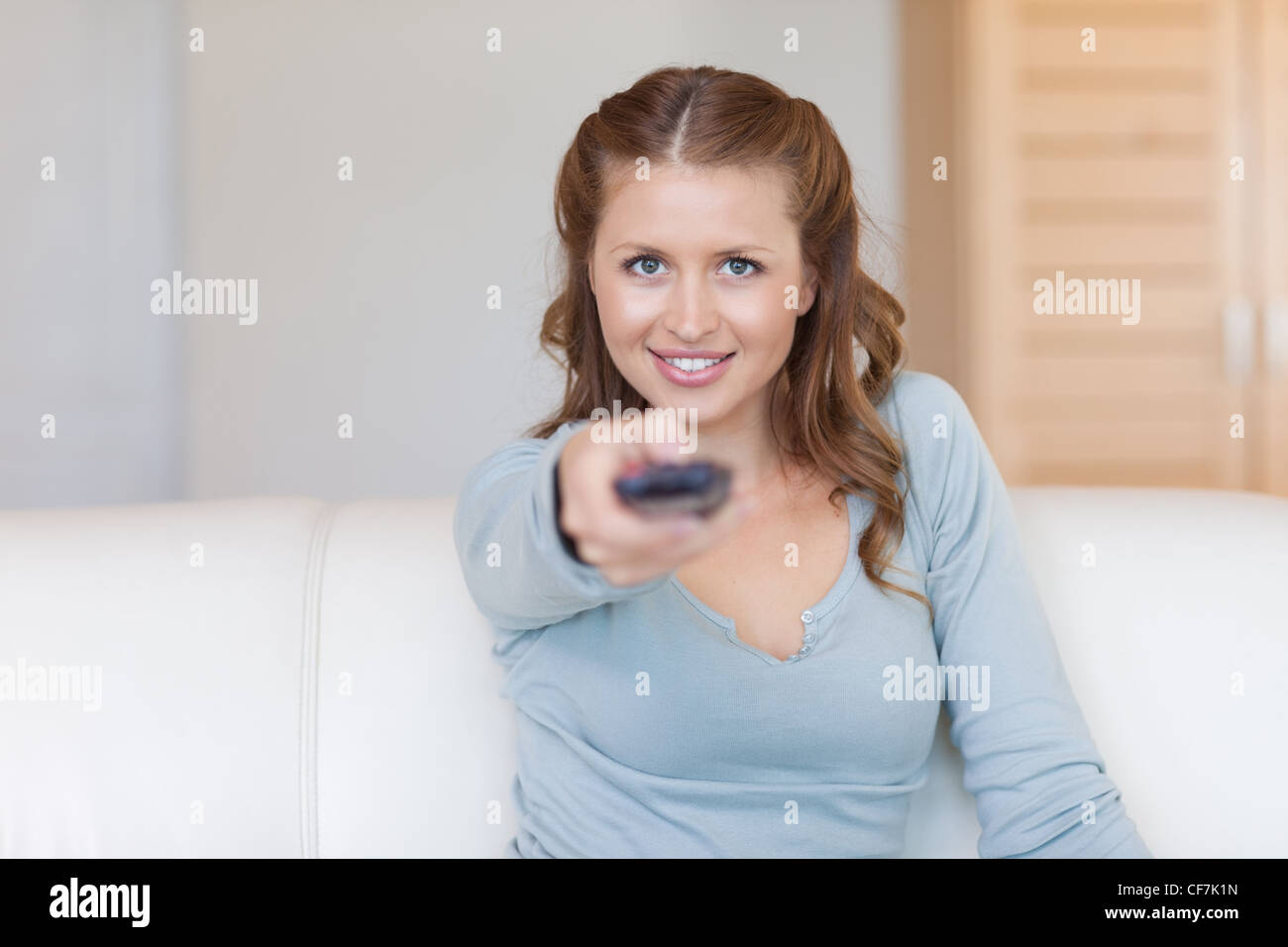 Young female using remote Stock Photo - Alamy