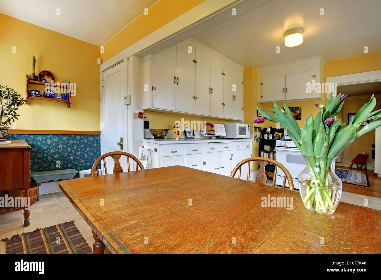 Old English charming kitchen with yellow walls and large table Stock ...