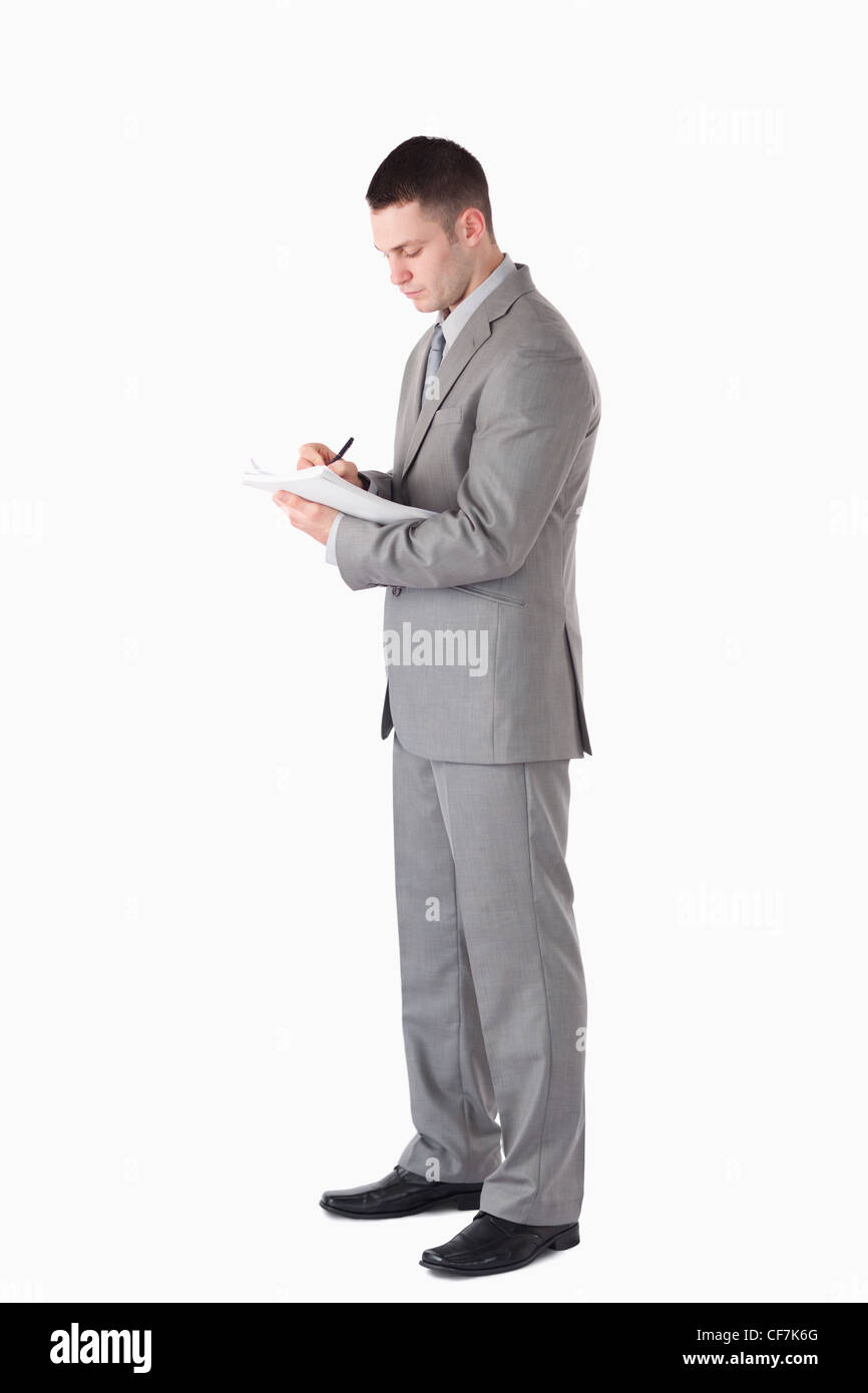 Portrait of a serious businessman taking notes Stock Photo - Alamy