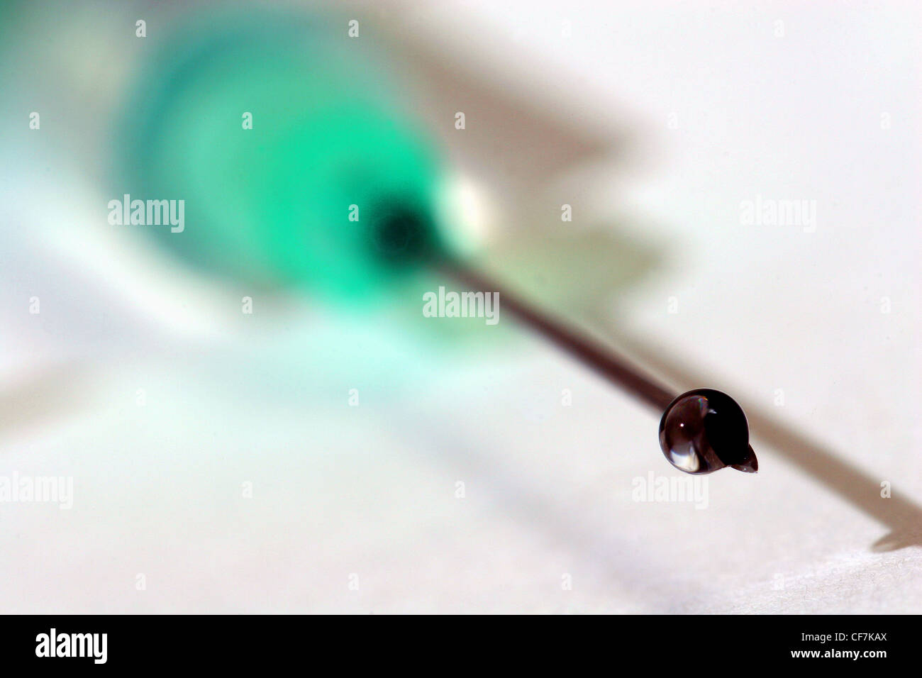 A close up of a syringe with a large needle attached to it, with a ...