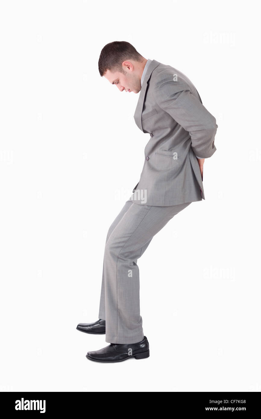 Portrait of a young businessman pushing a wall with his back Stock ...