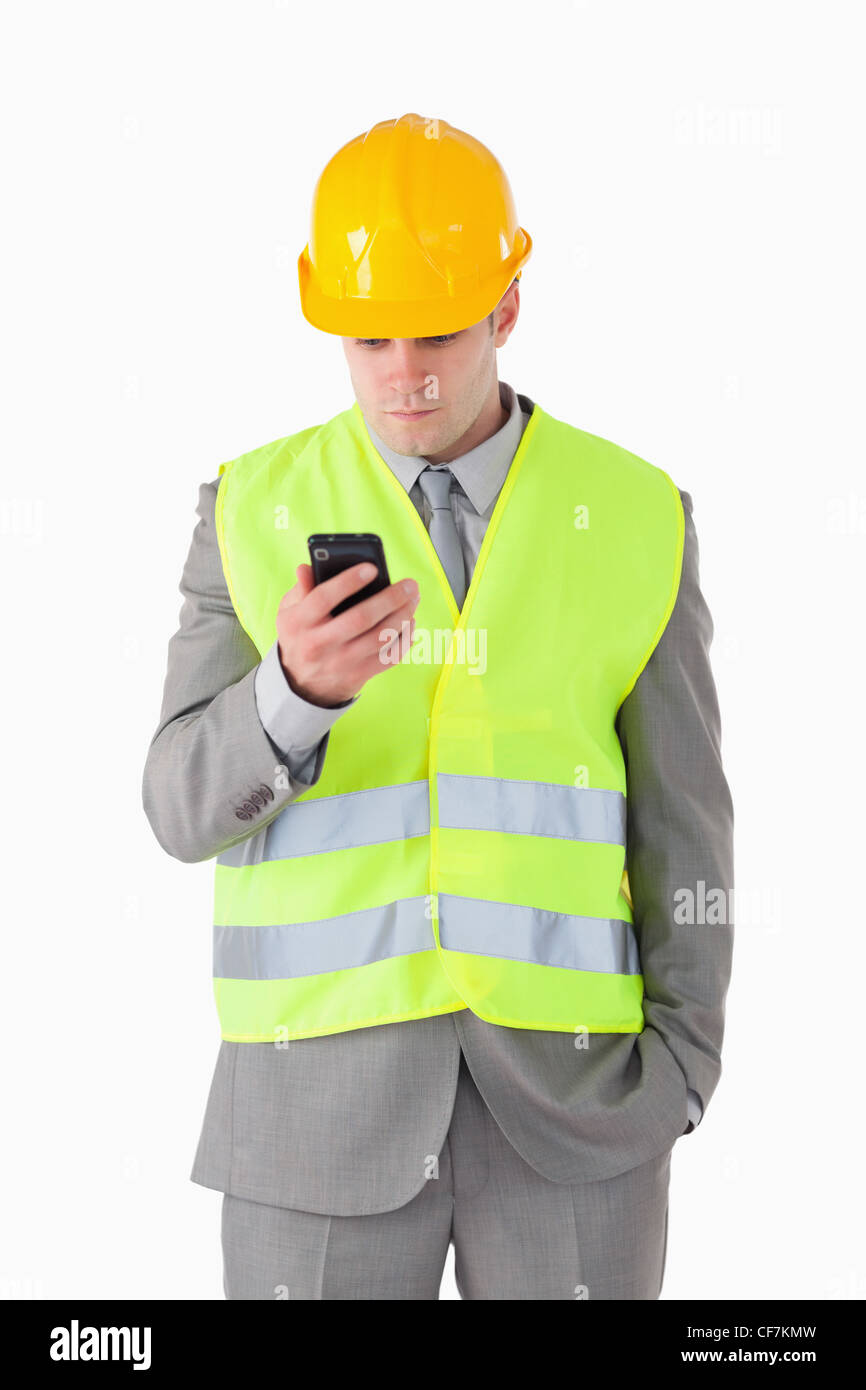 Portrait of a young builder looking at his cellphone Stock Photo - Alamy