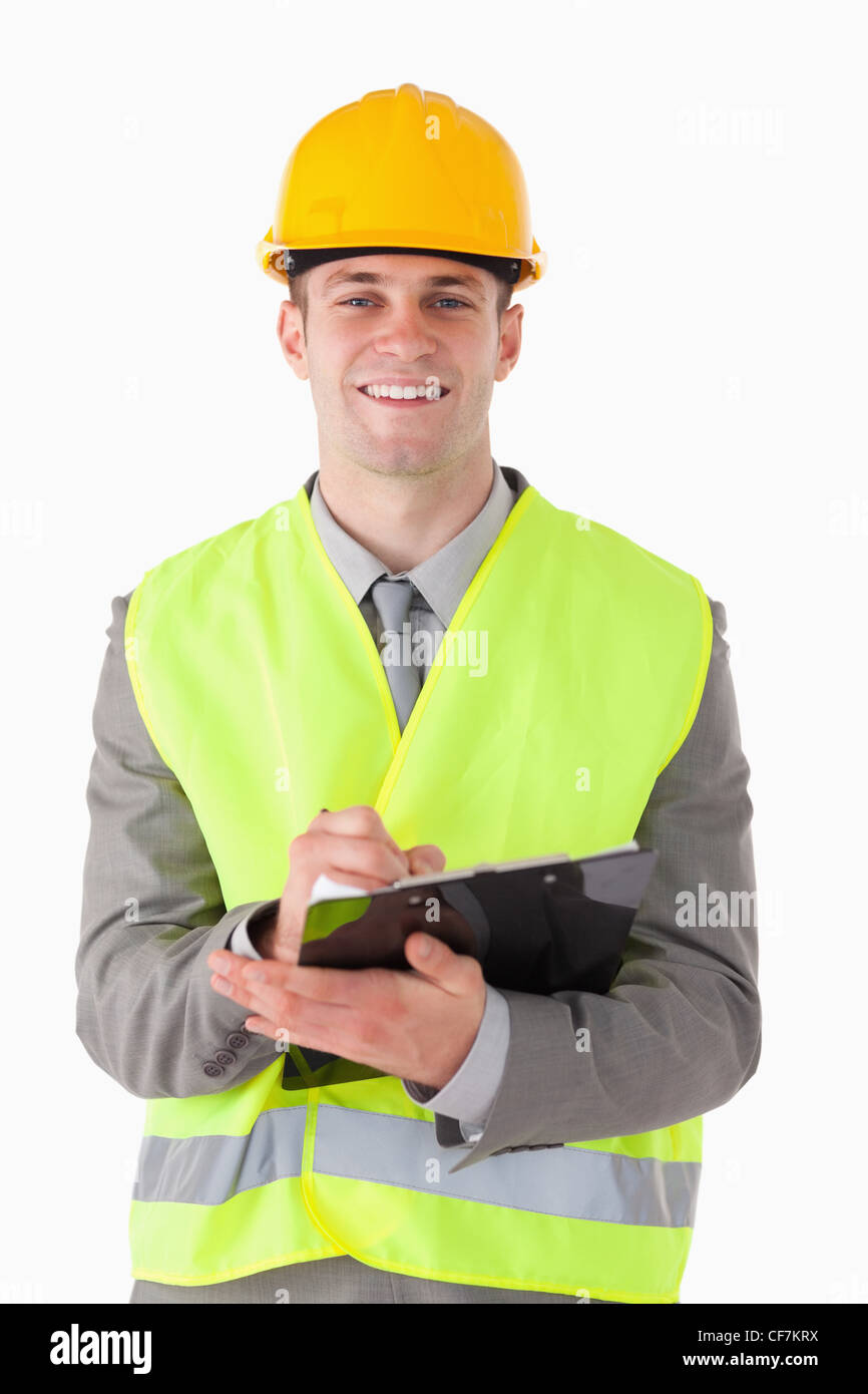 Portrait of a smiling builder taking notes Stock Photo - Alamy