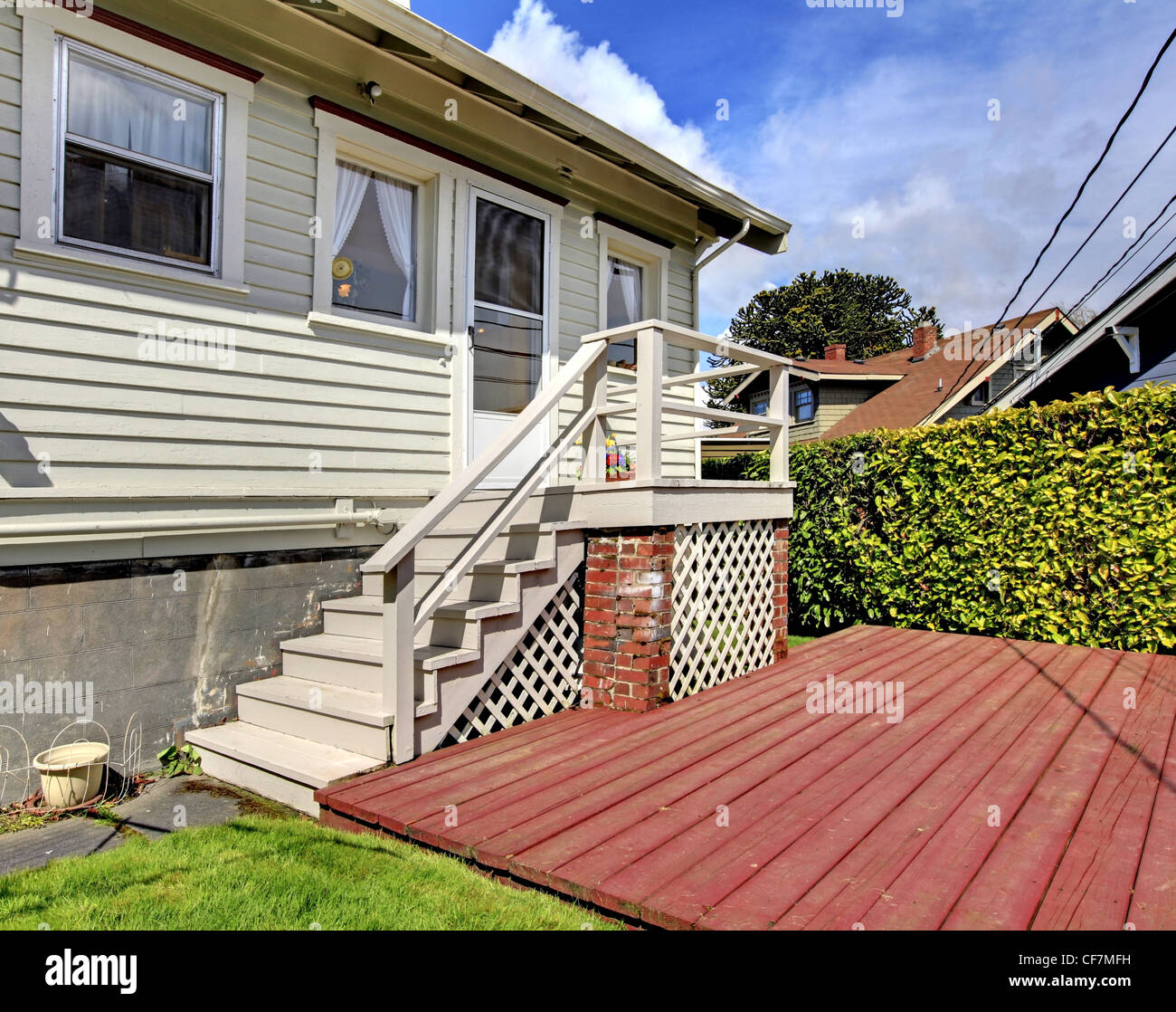 Corner of the grey old house with deck Stock Photo - Alamy