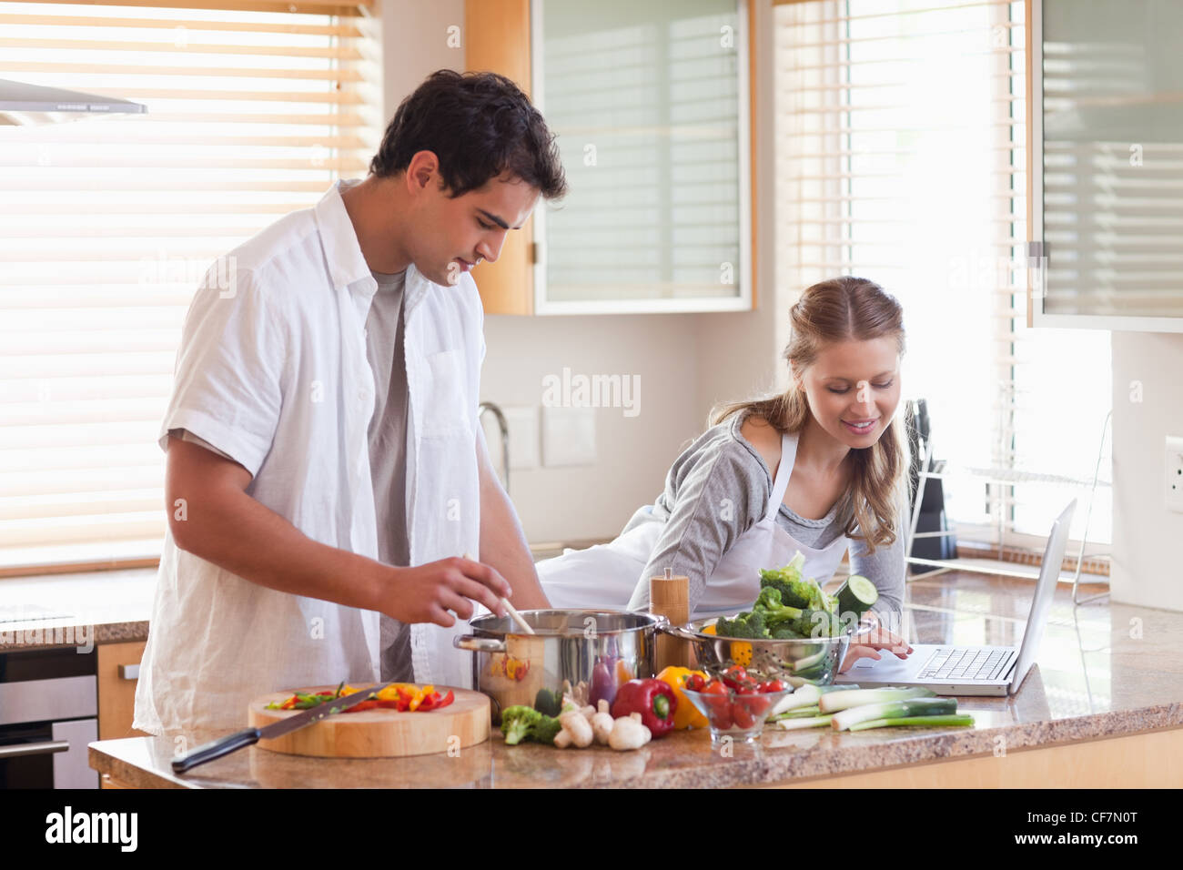 Woman looking up recipe up on the internet Stock Photo - Alamy